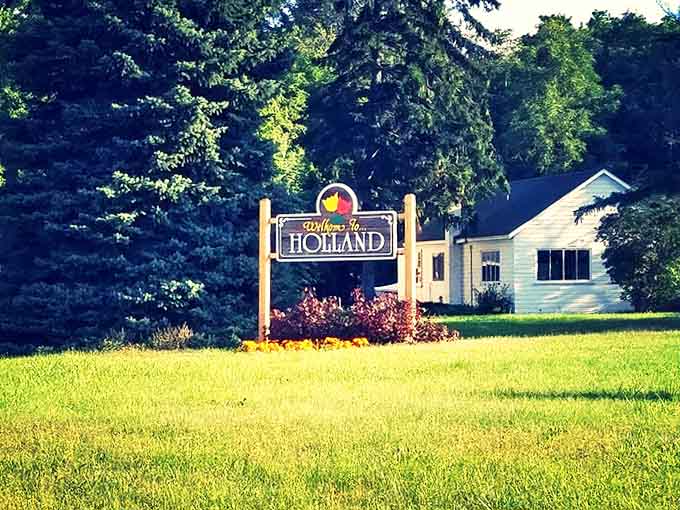 This charming entrance marker nestled among pines doesn't just say "Welcome to Holland" &ndash; it whispers "slow down, you've arrived somewhere special."