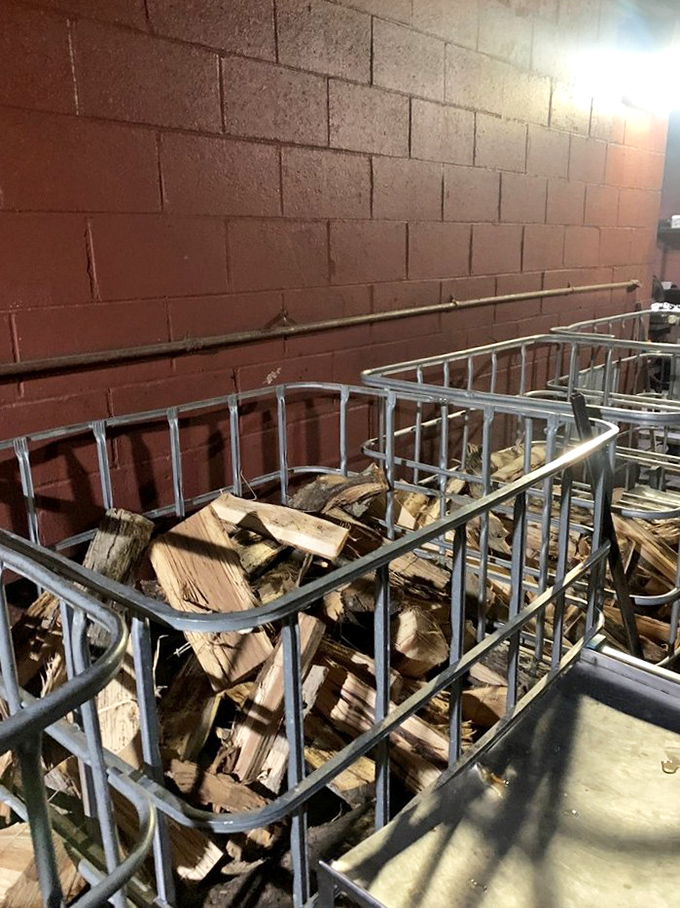 Stacks of seasoned wood waiting their turn &ndash; not just fuel, but an essential ingredient in the Ribber's flavor profile.