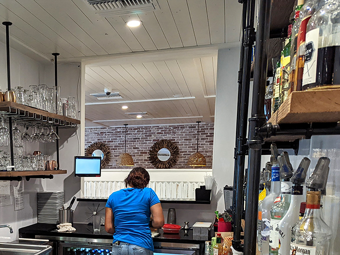 Behind the scenes where the magic happens &ndash; the bar area balances efficiency with warmth, keeping glasses filled and conversations flowing.