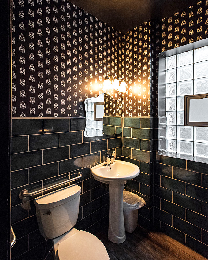 Even the bathroom continues the immersive experience &ndash; wallpapered with the bar's demonic mascot watching your every move.