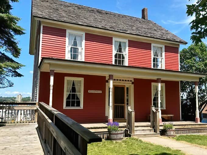 Bishop Baraga House's simple red exterior belies the complex history within, where 19th-century missionary work and frontier life intersect in preserved rooms and artifacts.