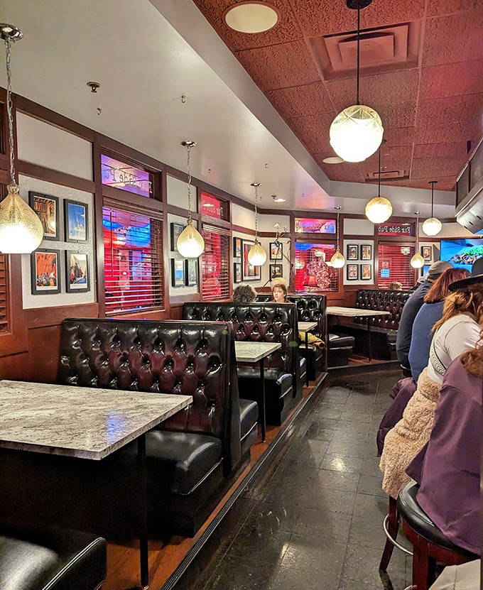 Plush leather booths invite lingering conversations over coffee and cocktails in a space that feels both timeless and thoroughly modern.