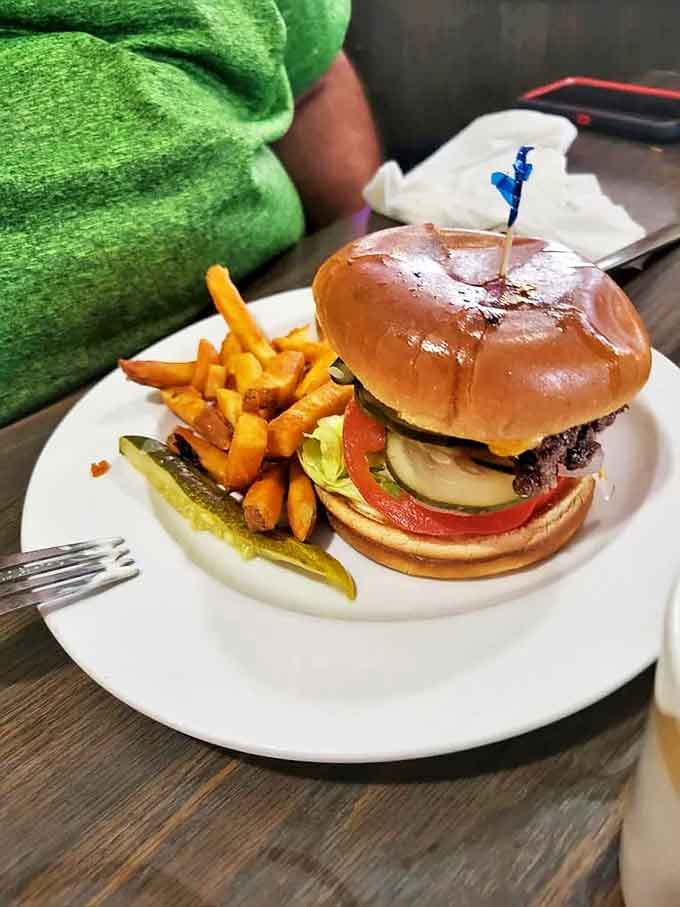 A classic burger with all the fixings and a pickle spear standing guard. No foodie hashtags needed &ndash; just honest-to-goodness satisfaction between two buns.