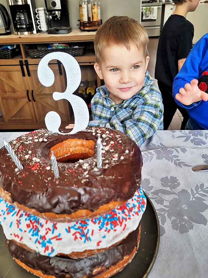 A birthday celebration made sweeter with a towering donut cake that puts ordinary birthday cakes to shame. Sugar-induced joy captured perfectly!