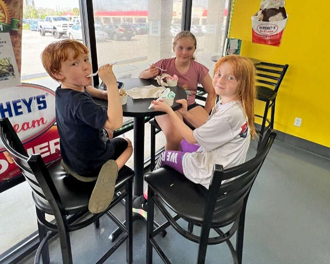 Young customers tackle their treats with the serious focus they deserve, creating memories around metal-topped tables that will last long after the ice cream melts.