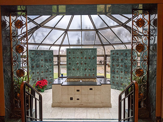 Ornate ironwork frames this stunning glass dome, where light filters through in patterns reminiscent of cathedral windows.