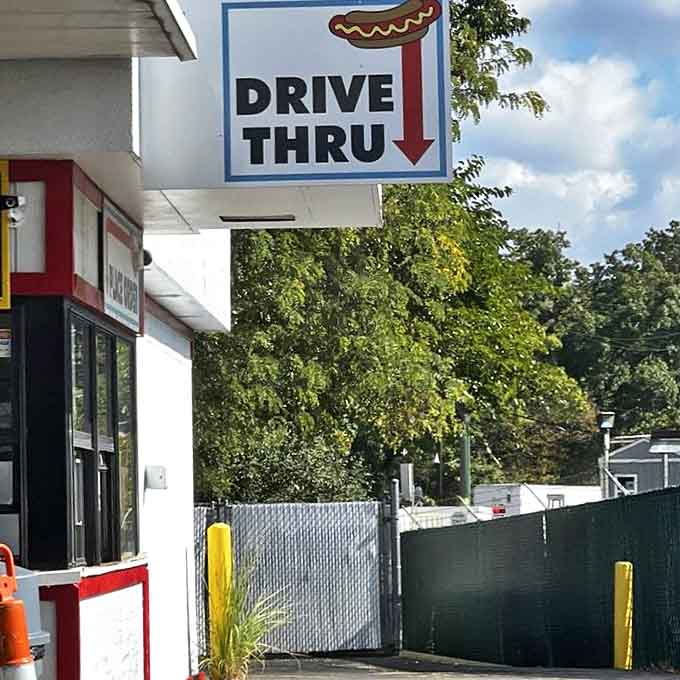 The drive-thru sign points the way to happiness &ndash; because sometimes the best meals come in paper bags passed through car windows.