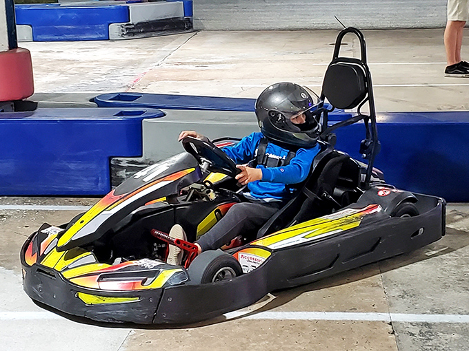 Young racers line up for their heat, each dreaming of victory while parents capture memories of this high-octane childhood milestone.