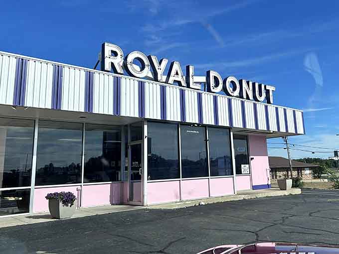 As evening falls, Royal Donut's illuminated sign serves as a lighthouse for those navigating the treacherous waters of dessert cravings.