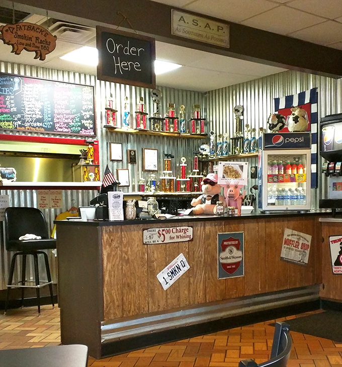 The counter where barbecue dreams come true, lined with trophies that tell you these folks aren't just playing at smoke and fire.