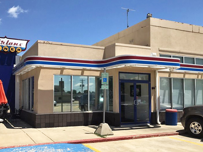 The Fairlane's clean lines and distinctive signage stand out against the blue Illinois sky, a mid-century modern masterpiece serving up slices of Americana.