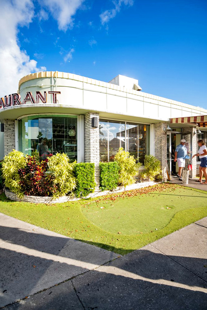 The curved corner entrance welcomes diners with mid-century charm, promising authentic experiences in an age of Instagram-engineered restaurant concepts.