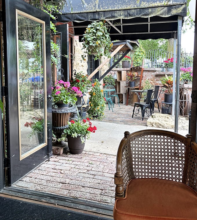 The garden courtyard offers a peaceful respite, where antique chairs invite you to sit among the flowers and contemplate your next treasure hunt.