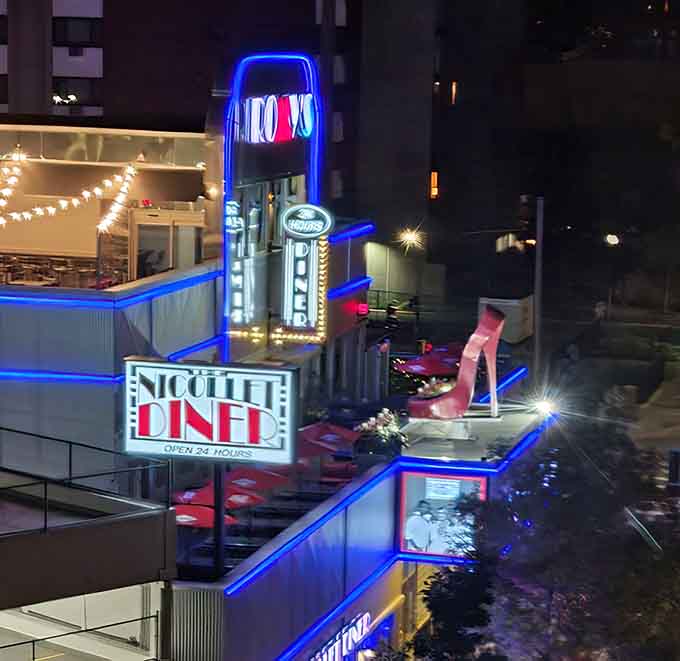 The outdoor patio transforms into an urban oasis at night, with colorful lights creating the perfect atmosphere for late-night dining.