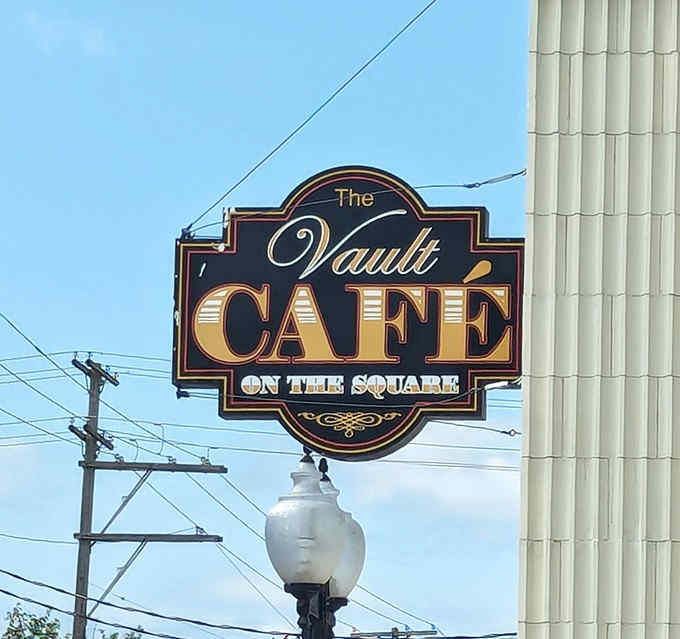 The Vault Cafe's sign hangs proudly on the historic building, a beacon for hungry travelers and locals alike.
