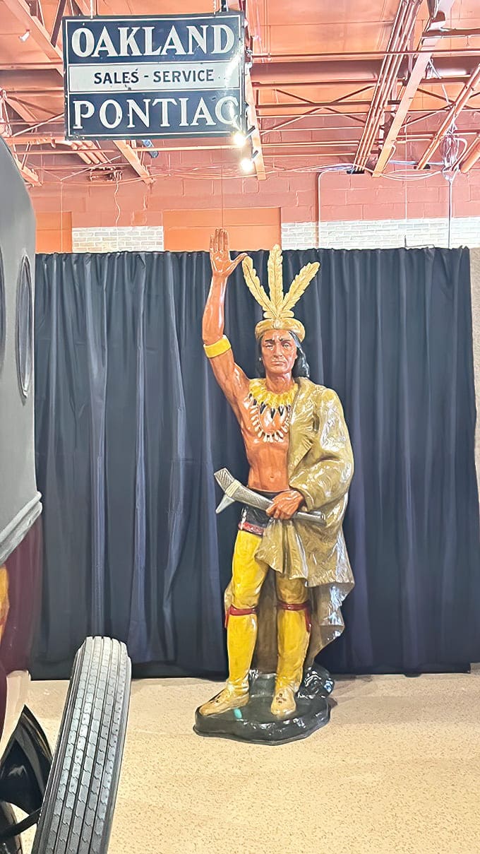 That vintage statue stands guard like a time traveler who decided this museum was worth sticking around for.