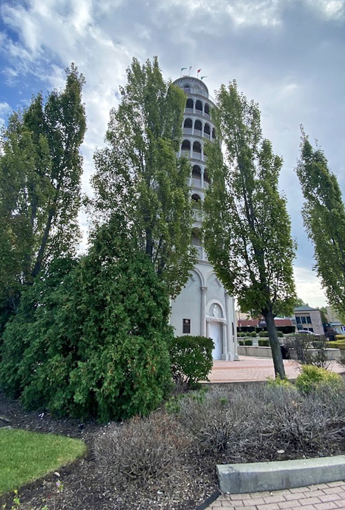 Nestled among mature trees, the tower appears to have always belonged in this suburban setting, despite its distinctly European design and famous tilt.