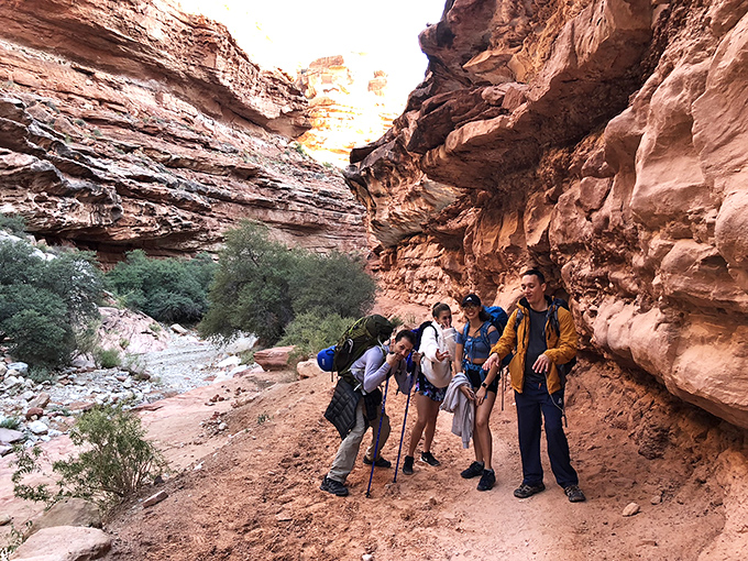 Adventure awaits: Fellow explorers navigate the narrow canyon trails, each step bringing them closer to paradise.