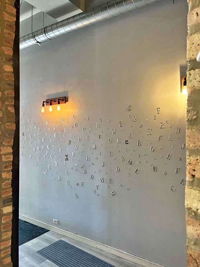 Magnetic letters scattered across the wall create a playful literary puzzle &ndash; look closely and you might discover hidden words among the alphabet soup.