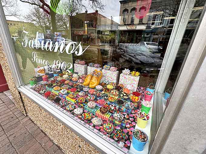 The window display at Fabiano's since 1902 showcases a kaleidoscope of colorful treats, enticing passersby with sweet possibilities.