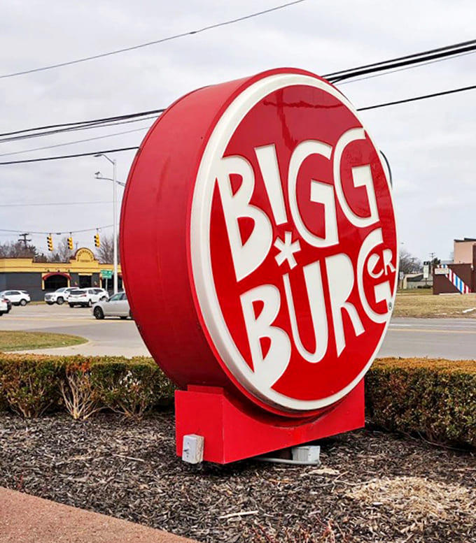 Signage: The iconic red Bigg Burger sign stands as a beacon for hungry travelers &ndash; a landmark that promises satisfaction lies ahead.