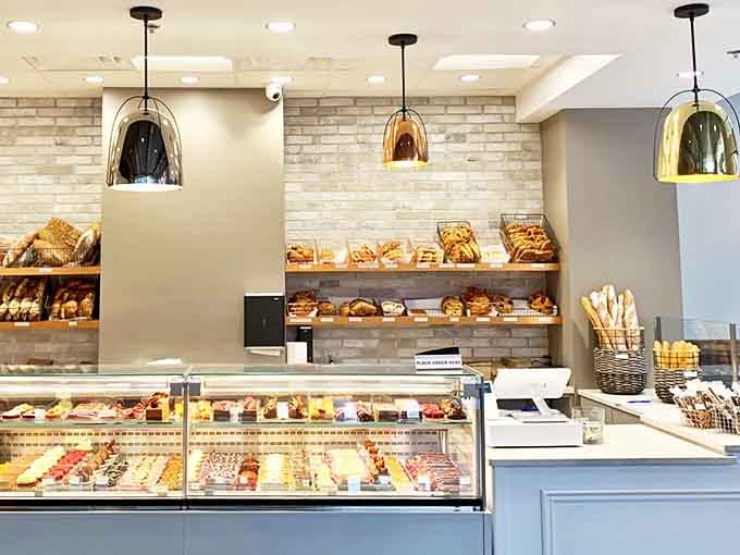 The counter where dreams come true &ndash; each glass-enclosed shelf offering a different path to butter-laden bliss.
