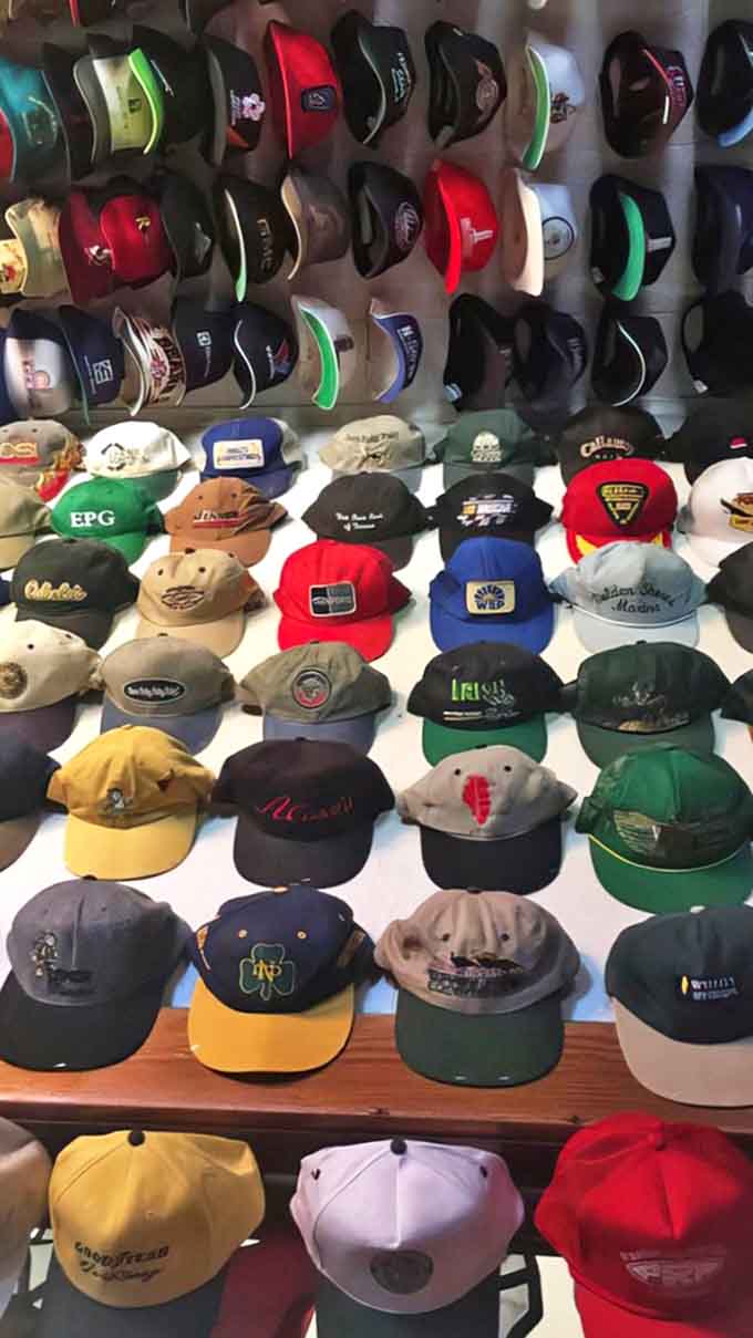 Corporate logos, team emblems, and promotional campaigns create a visual timeline of American marketing history, one hat at a time.