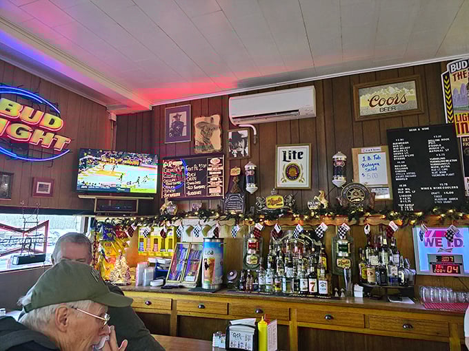 Beer signs glow against wood-paneled walls as regulars perch on barstools that have likely conformed to their exact dimensions over years of patronage.
