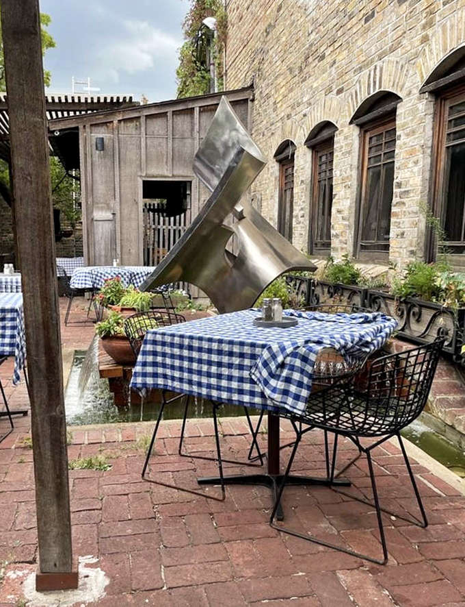 A modern sculpture adds unexpected artistic flair to the traditional biergarten setting &ndash; old-world charm meets contemporary Minneapolis cool.