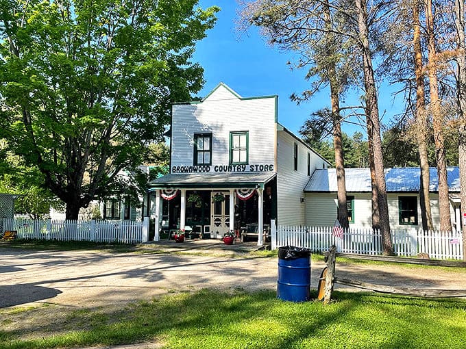 Sunlight bathes the white clapboard exterior in golden warmth &ndash; Brownwood Country Store stands as a beacon of sweetness amid Michigan's natural beauty.