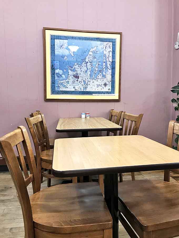 Simple wooden tables and chairs in soft lighting create the perfect spot to sit, sip, and pretend you have nowhere else to be.