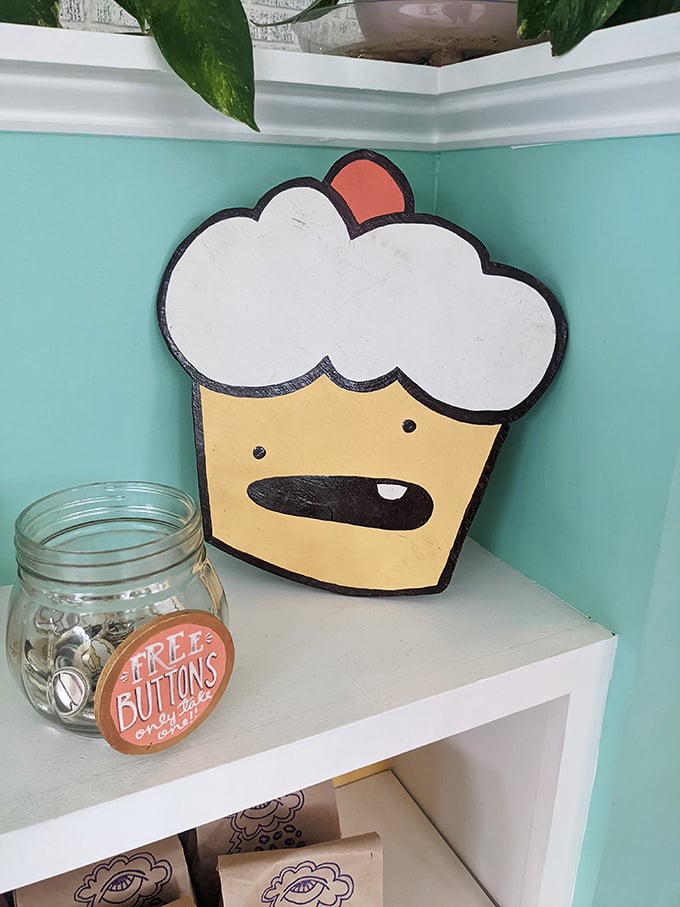 The bakery's cartoon mascot watches over its sweet domain with a smile that says, "Yes, it's all vegan, and yes, you're about to be amazed."