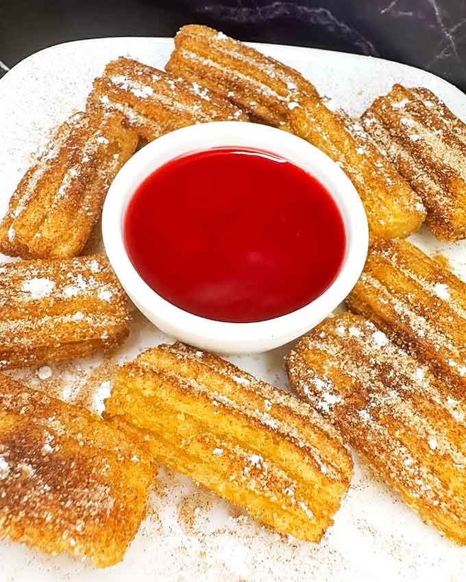 Crispy churros dusted with cinnamon sugar and served with strawberry dipping sauce&mdash;because plain churros are for quitters.