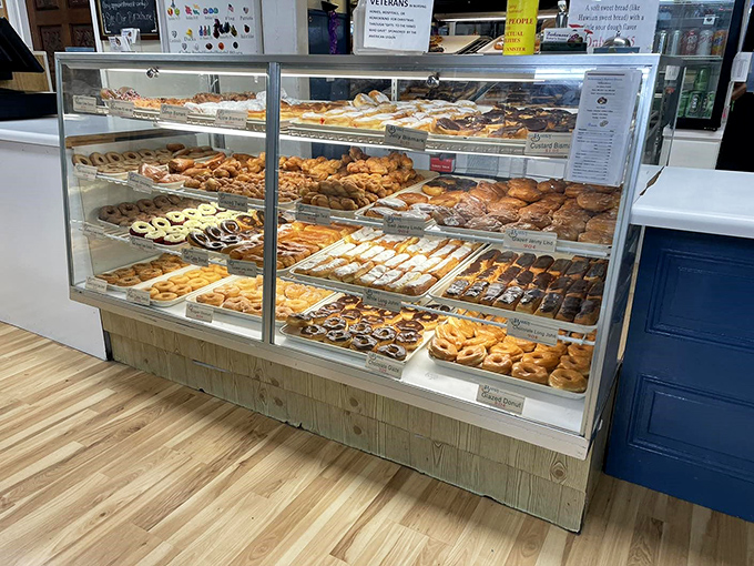 Display case dreams come true – row upon row of handcrafted perfection that makes diet plans crumble faster than fresh cookies.