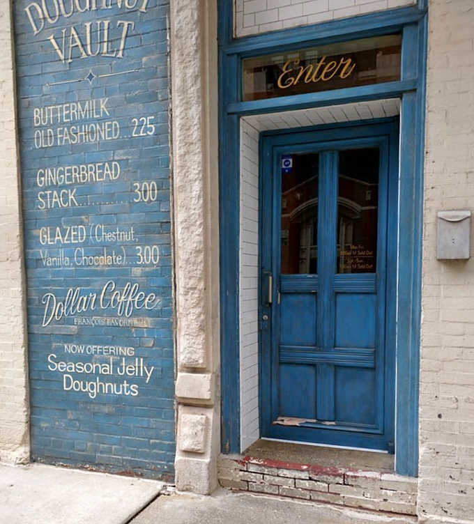 The blue entrance door and hand-painted menu wall serve as a beacon for the donut-obsessed, a portal to sweet satisfaction in downtown Chicago.
