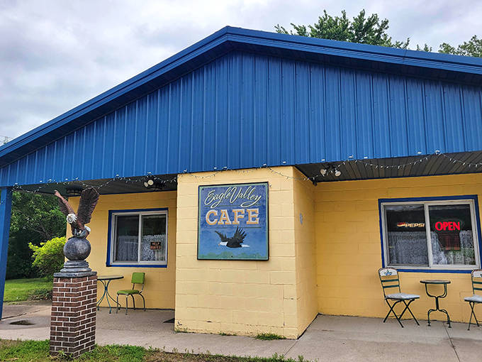 The cafe's exterior welcomes visitors with its eagle statue standing guard, promising authentic small-town dining experiences that chain restaurants can only dream of replicating.