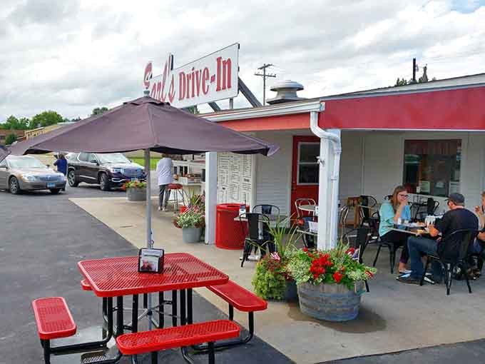 Red tables, colorful planters, and happy diners create the perfect outdoor dining scene at Earl's, where Minnesota summers are celebrated one meal at a time.