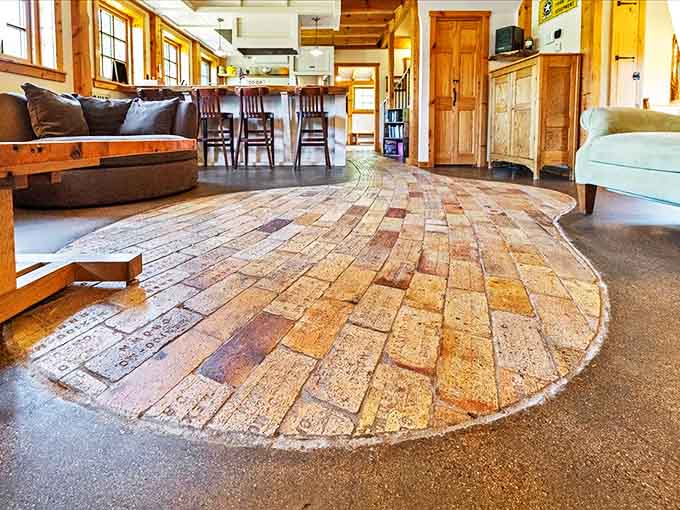 The reclaimed brick flooring creates a warm, textured surface that connects you to history while keeping things surprisingly cozy underfoot.