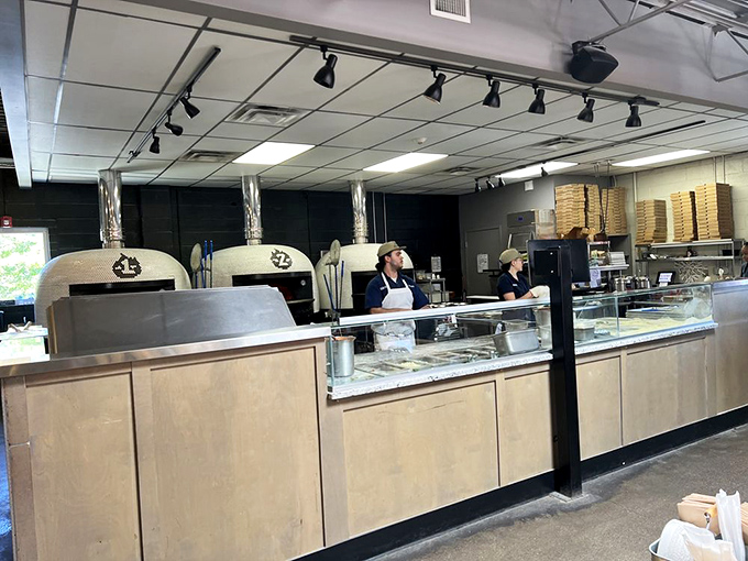 Behind the scenes where the magic happens &ndash; skilled hands preparing to transform simple ingredients into transcendent pizza experiences.