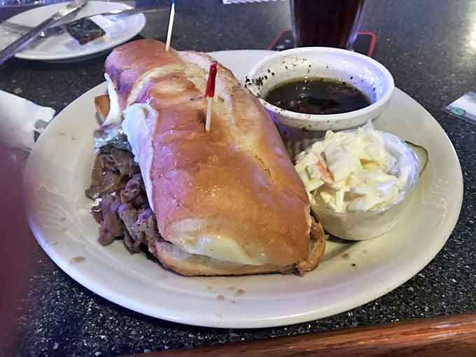 This French Dip isn't just a sandwich &ndash; it's tender beef taking a victory lap in a soft roll, with au jus standing by like a trophy presentation waiting to happen.