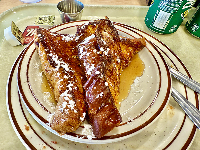 Challah French toast that makes you question why anyone bothers with regular toast &ndash; golden, eggy perfection under a snowfall of powdered sugar.