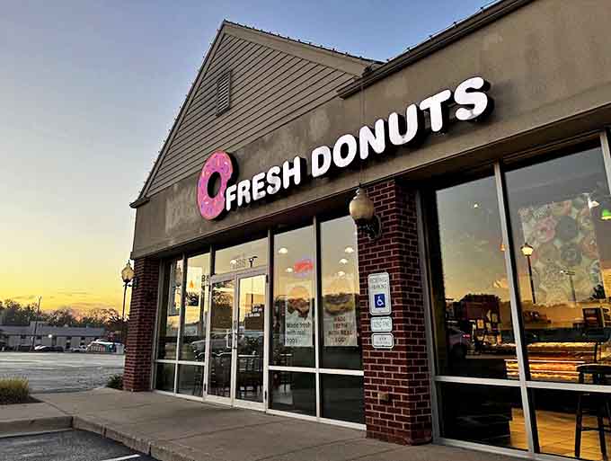As day turns to dusk, the Fresh Donuts sign glows like a beacon, promising that tomorrow will bring another chance for breakfast perfection.
