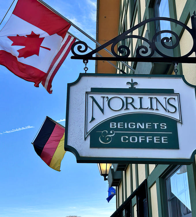 The hanging sign announces N'Orlins Beignets & Coffee to the world, a beacon for anyone craving a taste of the Big Easy in Michigan.
