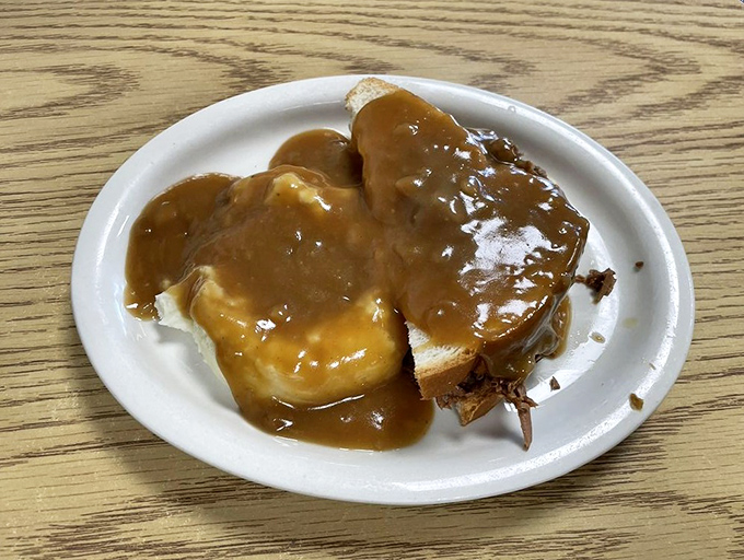 Hot beef on bread with gravy cascading down the sides &ndash; comfort food that whispers, "Everything's going to be okay" with every savory bite.