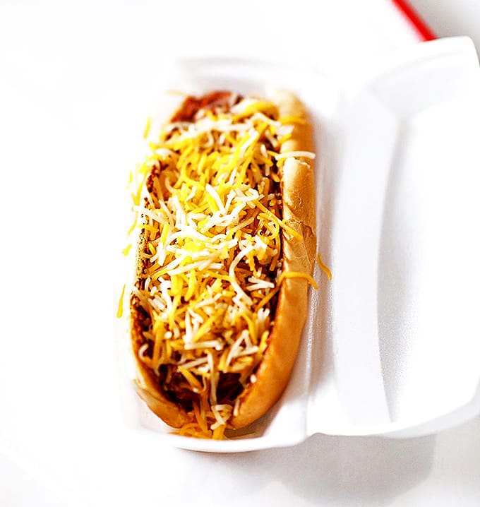 A humble hot dog elevated to art form with a blanket of melted cheese &ndash; proof that sometimes the classics need no improvement.