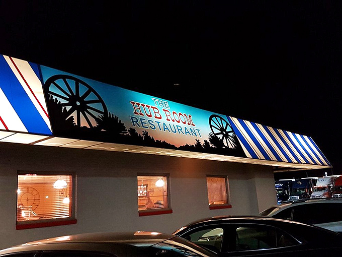 The Hub Room Restaurant's illuminated sign beckons hungry visitors with the promise of hearty, homestyle cooking.