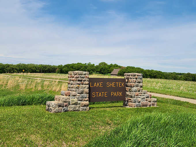 Signage: The stone entrance announces your arrival at Minnesota's best-kept secret, where adventure awaits just beyond the sign.