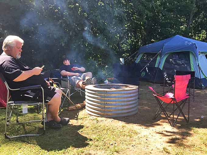 The timeless ritual of campfire conversation unfolds, where stories are shared and memories made against a backdrop of dancing flames