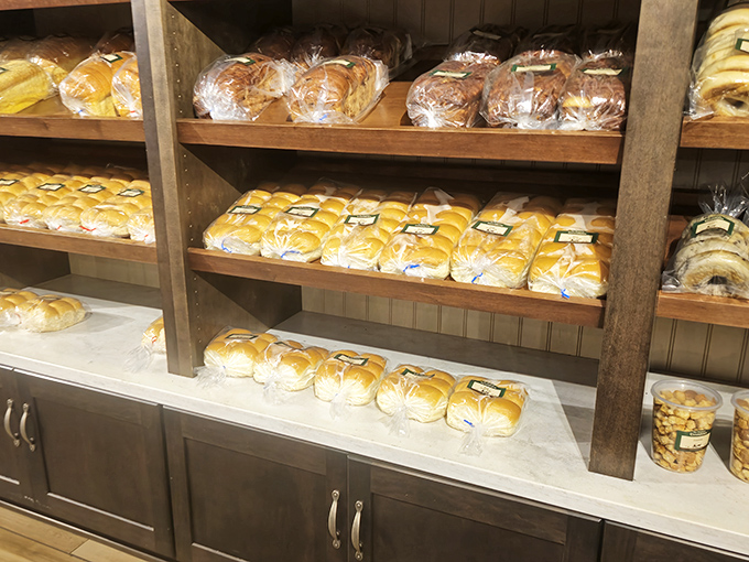 Fresh-baked bread lines wooden shelves like edible architecture, each loaf promising sandwiches and toast that will forever ruin store-bought alternatives.