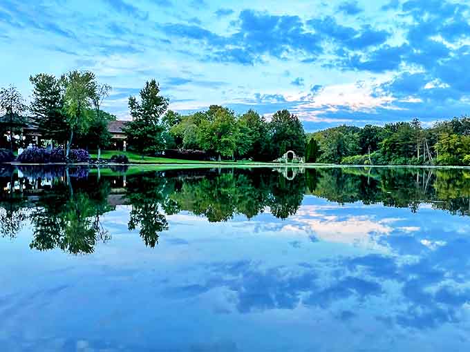 The lake at dusk creates mirror images so perfect you'll wonder if you're seeing double or if the wine tasting was more generous than expected.